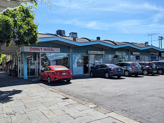 The iconic blue-trimmed facade of Donut Wheel stands like a beacon of sweetness on Livermore's First Street, promising delicious treasures within.