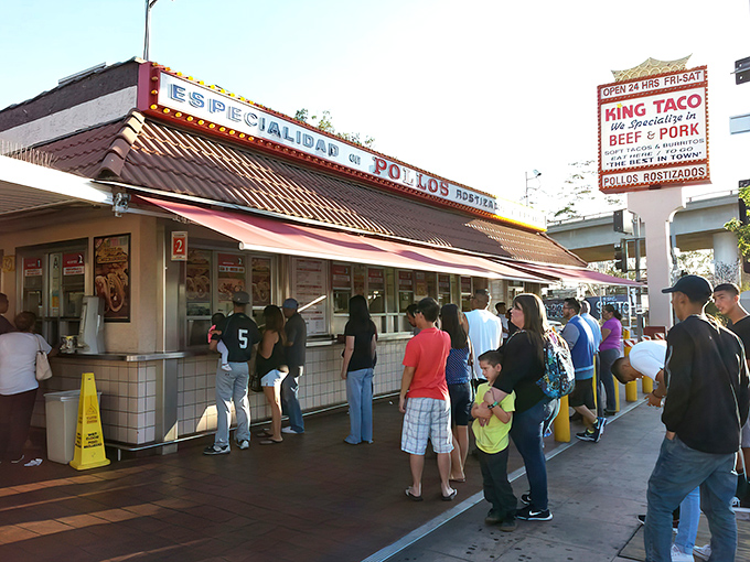 The iconic King Taco sign stands proud against the blue LA sky, promising culinary treasures that have kept locals coming back for decades.