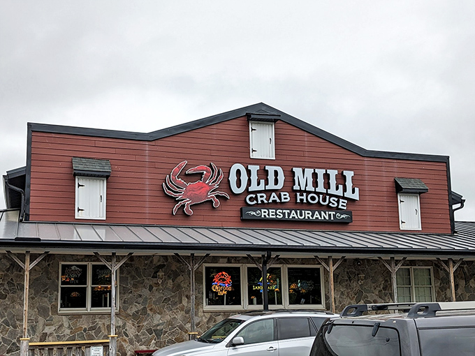 The rustic burgundy exterior with its bold crab logo promises seafood salvation for weary travelers. No pretension, just delicious anticipation.