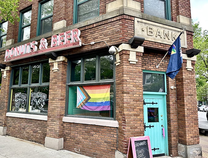 The historic brick building proudly announces its mission with glowing pink letters: DONUTS & BEER. That turquoise door is basically a portal to happiness.