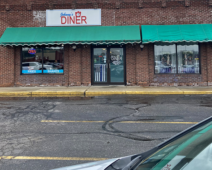 Johnny's Diner announces itself with understated charm &ndash; a brick facade, green awnings, and the promise of comfort food that'll make your day infinitely better.