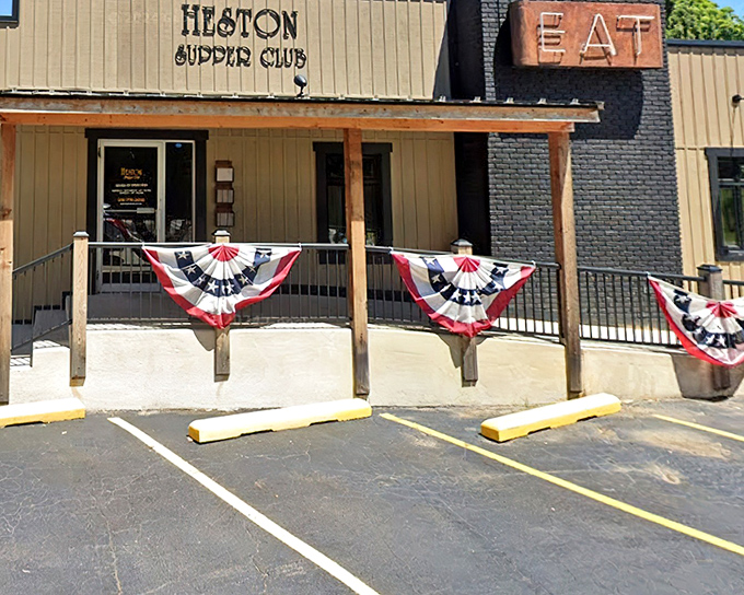The unassuming exterior of Heston Supper Club, where patriotic bunting and a simple sign promise Midwestern magic within. No flash, all substance.