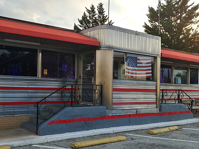 The classic silver-and-red exterior of Tastee Diner stands like a time machine on Route 1, complete with American flag proudly declaring its diner citizenship.