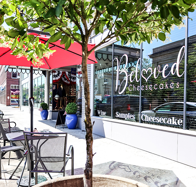 The storefront beckons with red umbrellas and promises of "Samples, Cheesecake, Coffee" &ndash; three magic words that could solve most of life's problems.