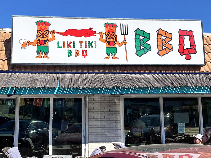 The neon glow of Liki Tiki BBQ beckons like a tropical lighthouse guiding hungry souls to barbecue paradise.