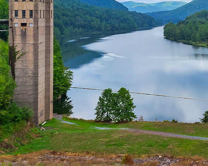The George B. Stevenson Reservoir stretches like a mirror between forested hills, reflecting the sky so perfectly you'll question which way is up.