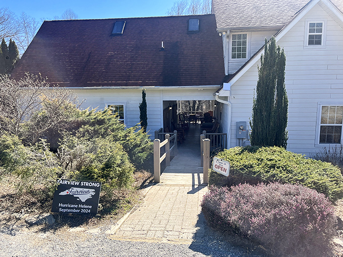A charming white farmhouse beckons with its stone pathway and "OPEN" sign &ndash; like a storybook cottage that happens to make incredible sandwiches.
