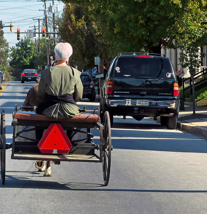 Where past meets present: an Amish buggy shares the road with modern vehicles, a perfect metaphor for Ephrata's charming time-travel experience.