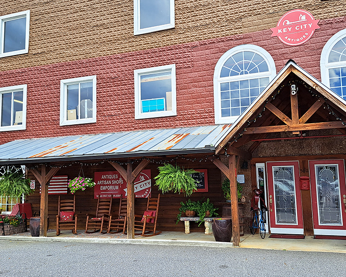 The welcoming facade of Key City Antique Mall beckons with rustic charm and the promise of treasures waiting just beyond those wooden beams.