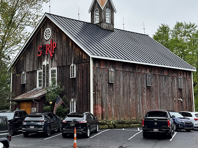 The rustic exterior of Strip Steakhouse beckons like a culinary time machine, where weathered barn wood houses modern gastronomic treasures waiting to be discovered.