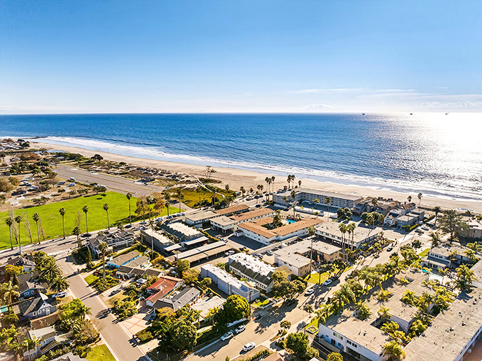 Sunset paints Carpinteria in golden hues, where palm trees stand like nature's exclamation points against the Pacific backdrop. California coastal living at its most sublime.