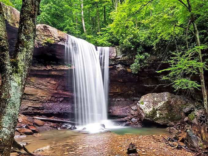 Nature's perfect curtain call: Cucumber Falls cascades 36 feet over ancient sandstone, creating a mesmerizing ribbon of white against the earthy backdrop.