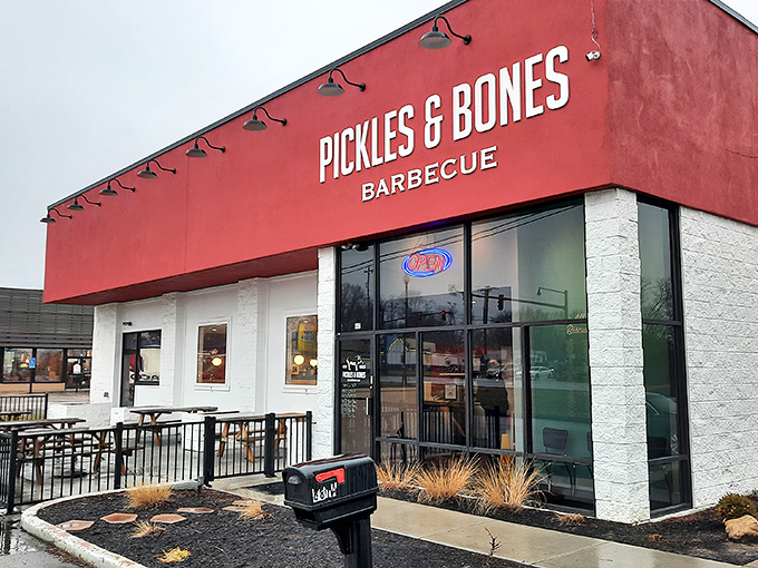 The bright red exterior of Pickles & Bones stands like a beacon for barbecue pilgrims, complete with a hand-drawn pig that practically winks at you.