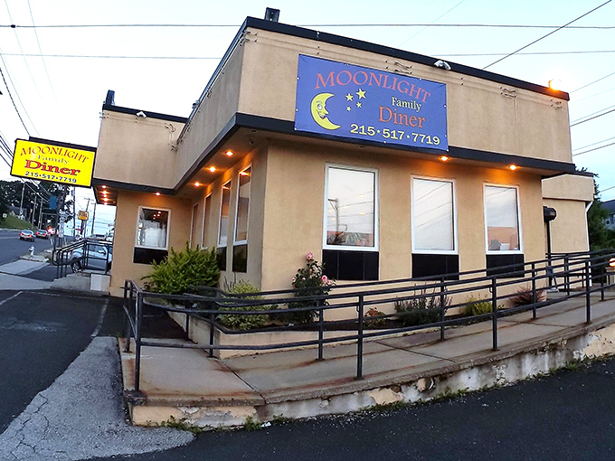 The iconic blue sign of Moonlight Family Diner glows like a beacon for hungry travelers. Pennsylvania's answer to midnight cravings and morning salvation.