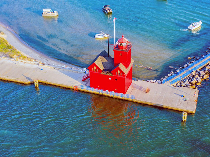 Big Red stands proud like a crimson sentinel guarding Lake Michigan's shores, proving lighthouses don't need height to make a statement.