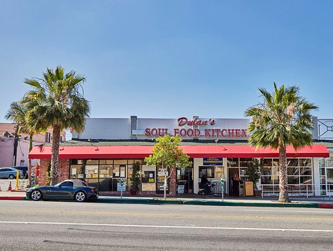 The red awning beckons like a culinary lighthouse on Manchester Boulevard—this is where soul food dreams come true in Inglewood.