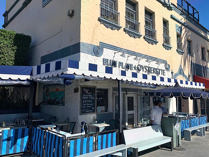 The blue-and-white striped awnings of Blue Plate Oysterette beckon like a maritime flag signaling "delicious food ahead" on Ocean Avenue.