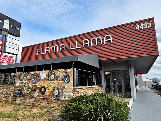 The striking red exterior of Flama Llama stands out like a culinary lighthouse, beckoning hungry San Diegans with its playful name and artistic plate display.