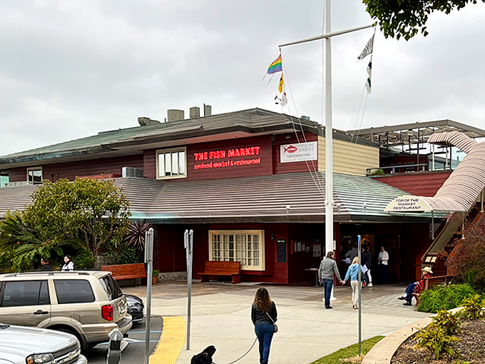 The Fish Market's nautical exterior stands like a welcoming lighthouse for hungry seafood pilgrims. Those flags aren't just for show&mdash;they're signaling "fresh catch ahead!"