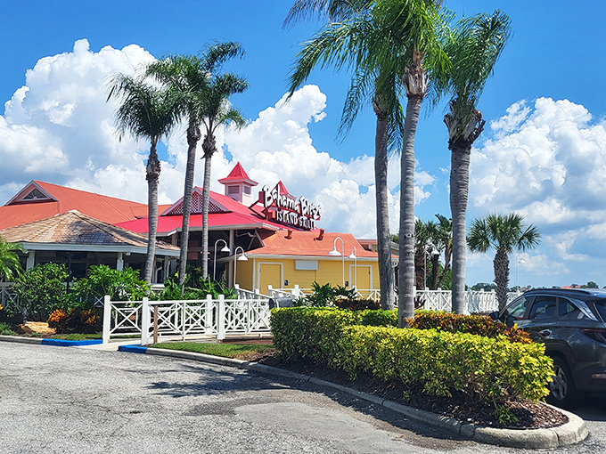 The iconic yellow and orange exterior of Bahama Breeze stands like a tropical oasis in Tampa, complete with that signature red roof that practically screams "vacation starts here!"