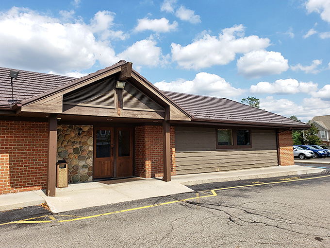 The rustic stone and timber exterior of Alibi of Troy beckons like a cozy northern Michigan lodge that somehow landed in the suburbs.