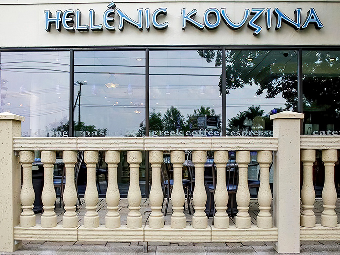 The blue sign beckons like a Mediterranean lighthouse against Pennsylvania greenery. Spring cherry blossoms add a touch of pink perfection to Hellenic Kouzina's inviting patio.