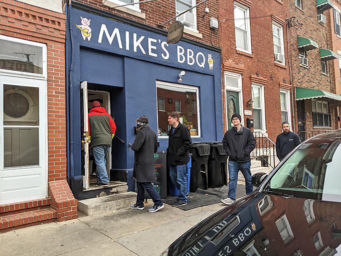 The bright blue storefront of Mike's BBQ stands out on East Passyunk Avenue like a beacon for meat lovers. The sidewalk tent hints at the smoky treasures waiting inside.