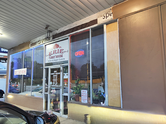 The unassuming storefront of Erie Curry House beckons with its simple red lotus logo and promise of Indian and Nepali cuisine—proof that culinary treasures often hide in plain sight.