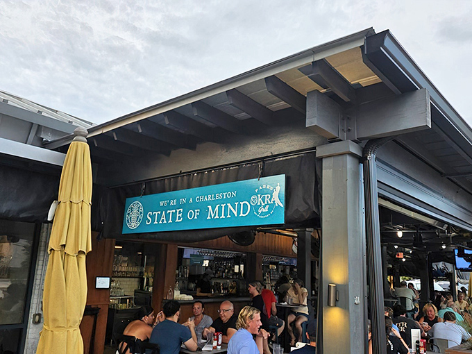 The iconic blue "Charleston STATE OF MIND" sign welcomes hungry patrons to Page's Okra Grill, where Southern hospitality begins before you even step inside.