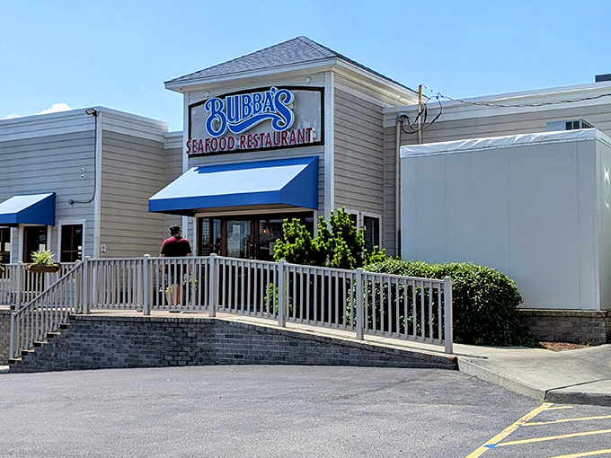 Bubba's glows like a beacon for seafood lovers at twilight, its weathered white exterior and welcoming deck promising maritime delights within.