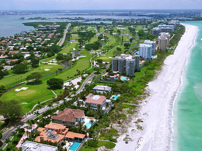 Paradise from above: where golf courses meet pristine beaches and the water shifts between emerald and sapphire like nature's mood ring.