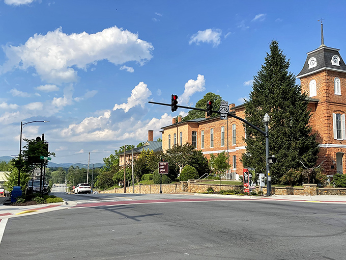 Main Street Brevard stretches toward the Blue Ridge Mountains like a postcard come to life, where brick buildings and mountain views create small-town perfection.