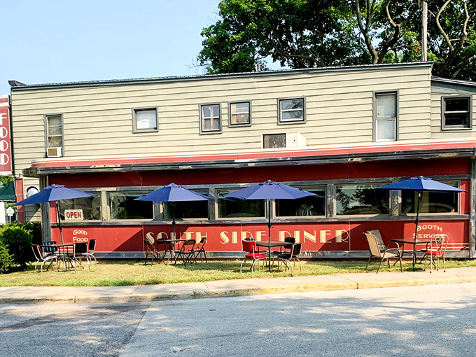 The iconic red exterior of South Side Soda Shop stands like a time capsule on Goshen's Main Street, complete with blue umbrellas inviting you to linger on sunny afternoons.