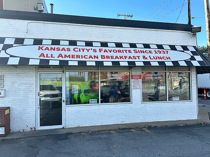 The classic black-and-white checkered awning isn't just decoration&mdash;it's a beacon calling hungry souls to breakfast paradise on Grand Boulevard.