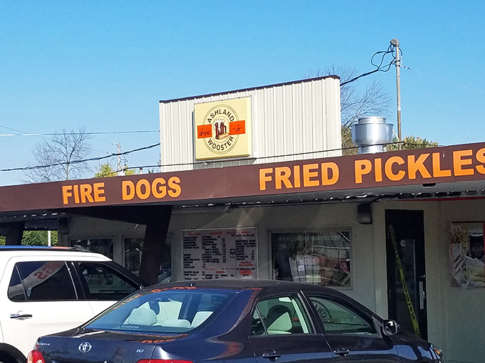 The unassuming exterior of Ashland-Wooster Drive-In stands as a time capsule of Americana, where that neon "HOMEMADE ROOT BEER" sign promises liquid gold awaits.