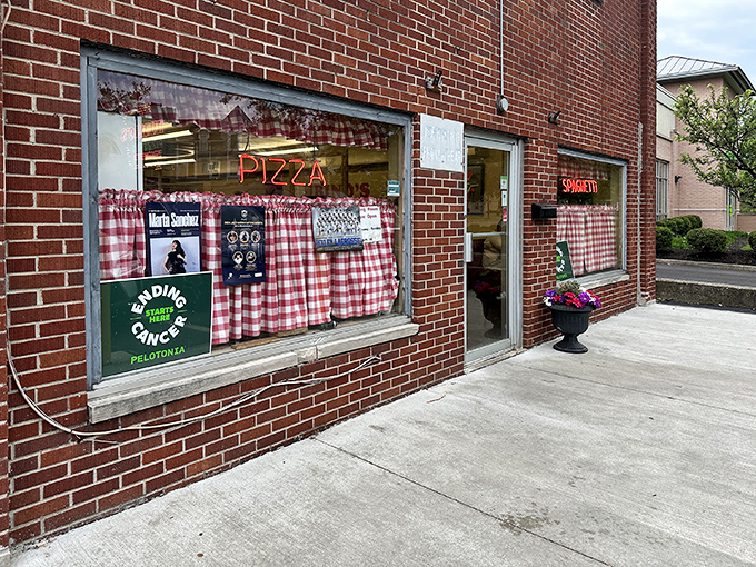 The classic red-and-white checkered curtains and neon signs aren't trendy design choices&mdash;they're time machines to when pizza joints were neighborhood institutions, not Instagram backdrops.