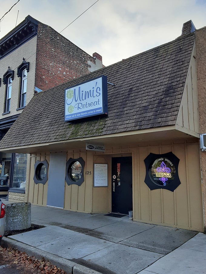 The unassuming exterior of Mimi's Retreat proves once again that culinary treasures often hide behind modest facades. Those porthole windows hint at nautical charm inside.