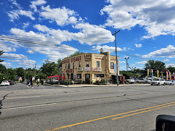 The corner landmark that launched a thousand cravings. Leo's beige exterior with bold red lettering stands as a Delaware County institution under Pennsylvania's big blue sky.