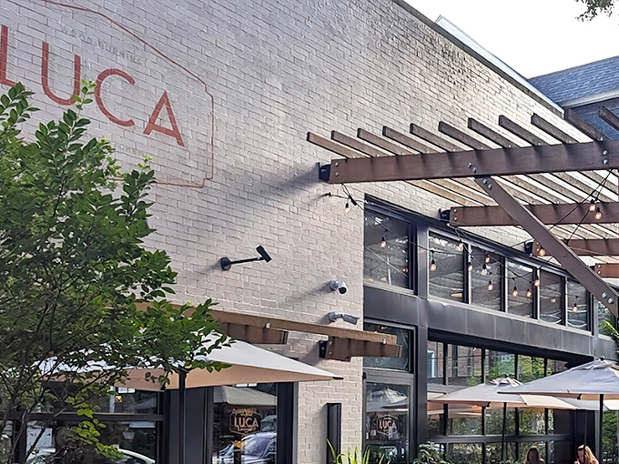 LUCA's pristine white exterior whispers elegance rather than shouting it, with that wooden pergola promising Italian magic before you even step inside.