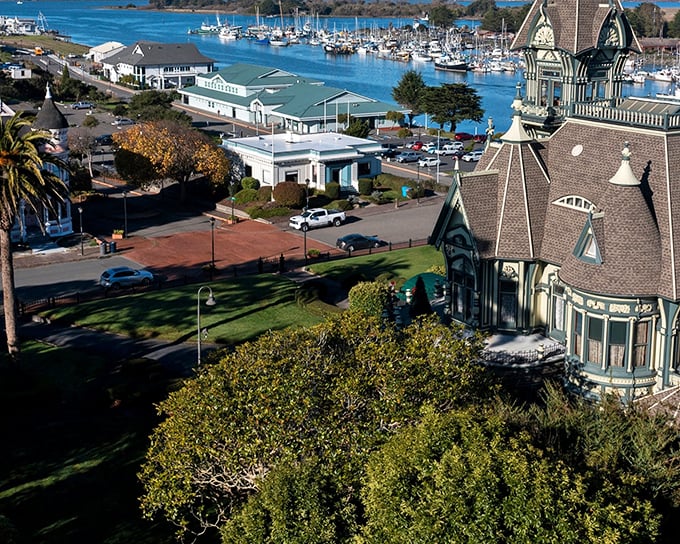 Eureka's Carson Mansion stands like a Victorian confection against the backdrop of Humboldt Bay, where fishing boats bob gently in the harbor's embrace.