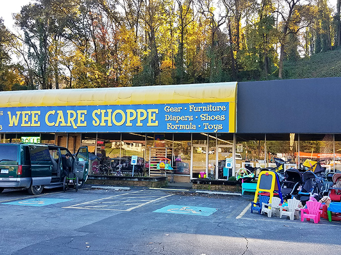 The blue-awninged facade of Wee Care Shoppe stands like a beacon of bargain hope for parents, with colorful outdoor merchandise hinting at treasures within.
