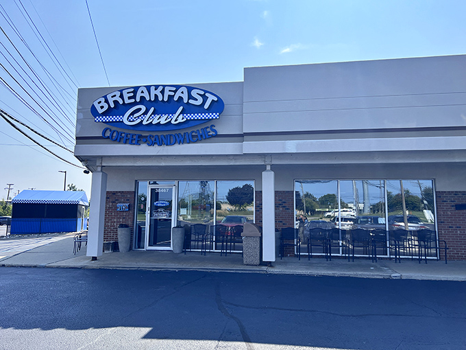 The blue and white sign of Breakfast Club stands out like a beacon for hungry travelers. Michigan mornings deserve this kind of welcome.