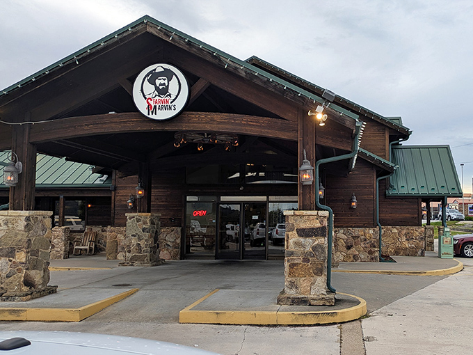 The rustic lodge-style exterior of Starvin Marvin's beckons hungry travelers like a siren song for seafood lovers in the Ozark hills.