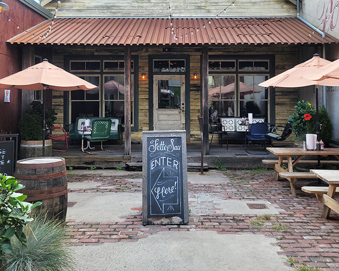 The rustic charm of Fette Sau's exterior beckons like a siren song for barbecue lovers. Weathered wood, brick pavers, and that chalkboard sign promising smoky treasures within.