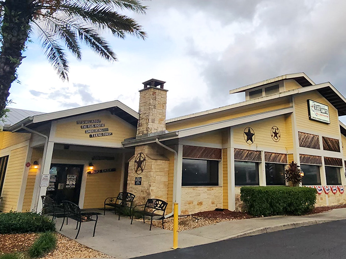 The sunshine-yellow exterior of Texas Tony's stands as a barbecue beacon in Naples, complete with rustic stone chimney and Western star accents.
