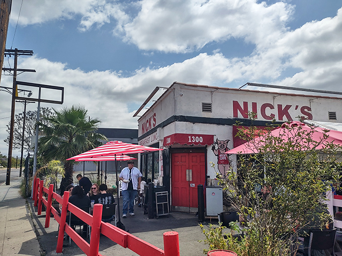 The iconic white building with red trim stands like a beacon of breakfast hope on Spring Street, promising morning salvation to hungry Angelenos.