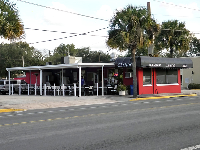 The bright red exterior of Christo's Cafe stands out like a culinary beacon in Orlando, promising comfort food that transcends ordinary diner fare.