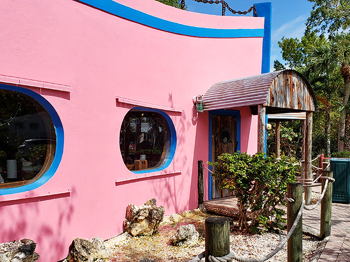 That pink exterior isn't just a building&mdash;it's a promise of Florida fun wrapped in Caribbean color. The blue-trimmed windows peek out like portholes on this seafood sanctuary.