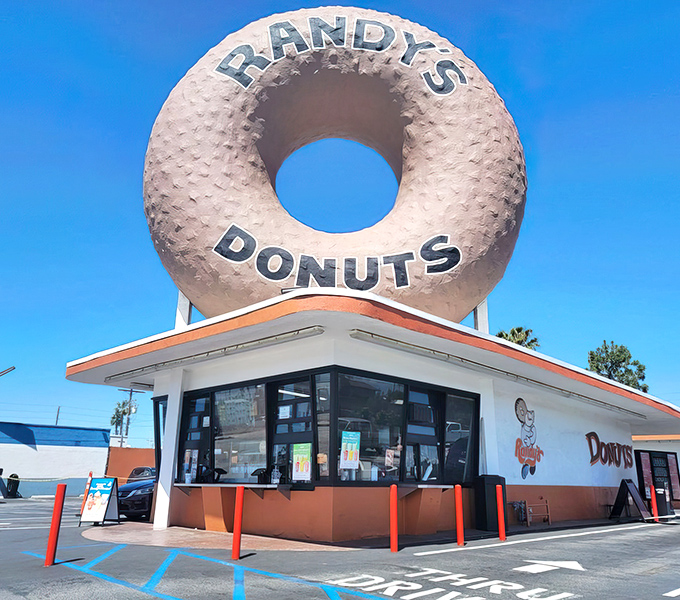 The mothership has landed! Randy's iconic 32-foot donut beckons sugar enthusiasts from miles away, a beacon of sweetness against the California sky.