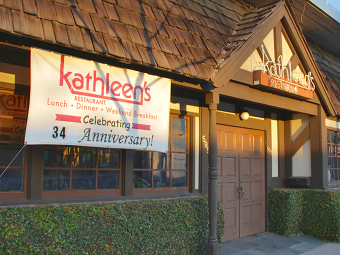 The charming cottage-like exterior of Kathleen's Restaurant beckons with its stone facade and distinctive blue doors&mdash;like a storybook breakfast haven come to life.
